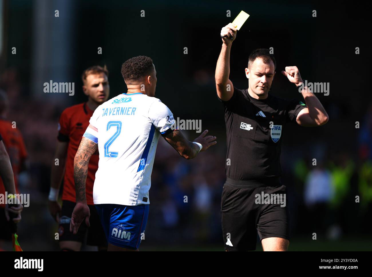 Rangers' James Tavernier (left) reacts after being shown a yellow card ...