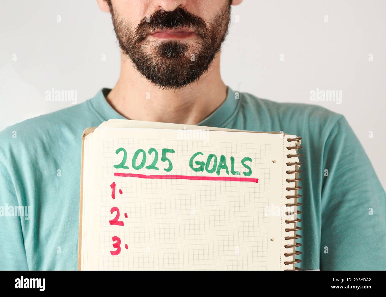 A handsome caucasian men show his goals for 2025 years. Three goals for ...