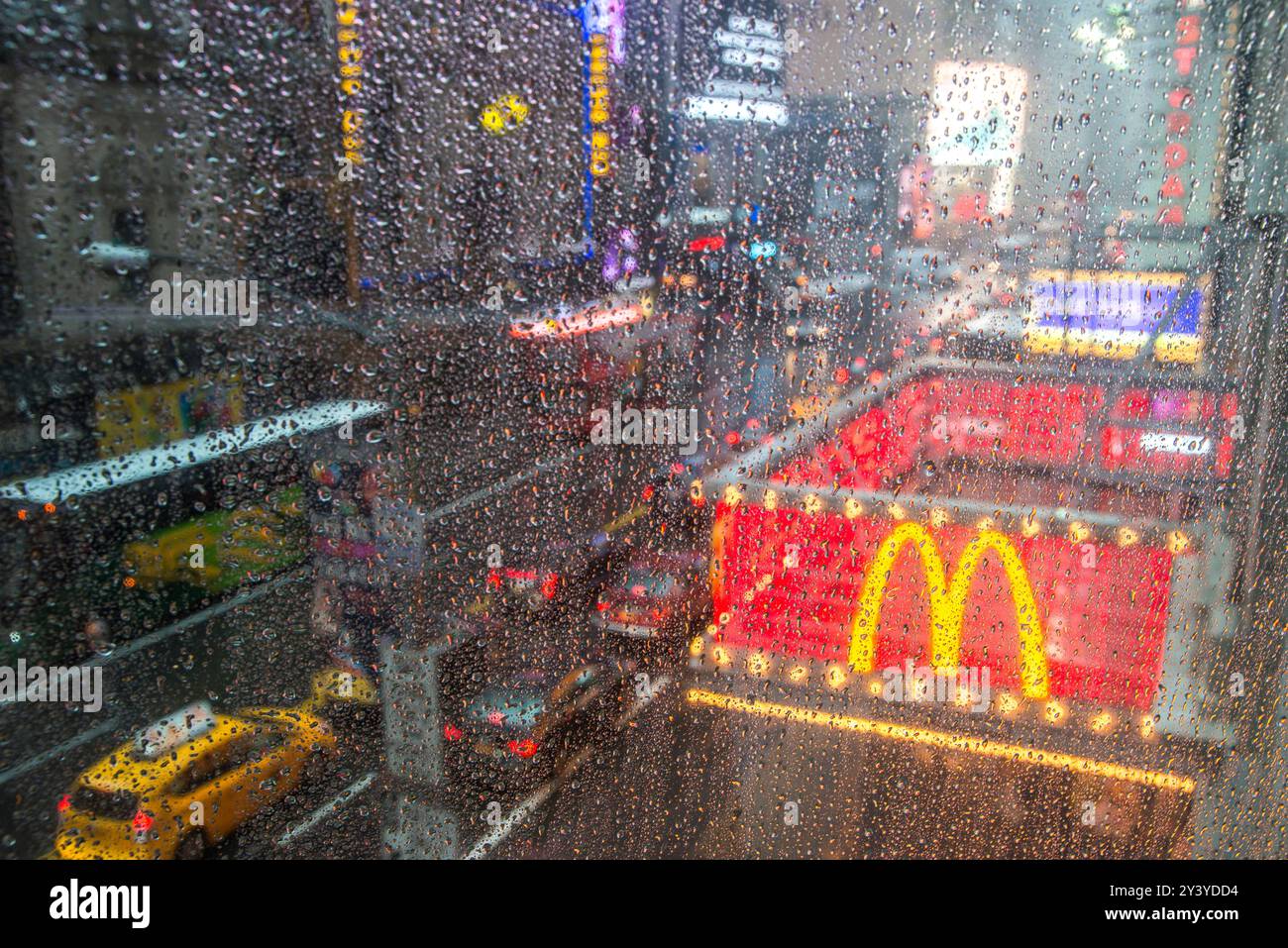 Times Square, New York: Street and Neon Signs Behind a Rain-Covered ...