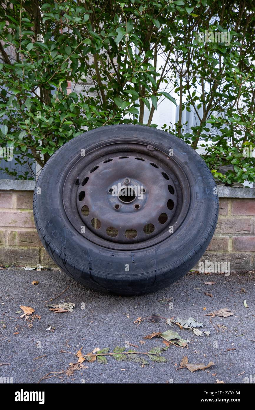 Abandoned wheel left against a wall Stock Photo - Alamy