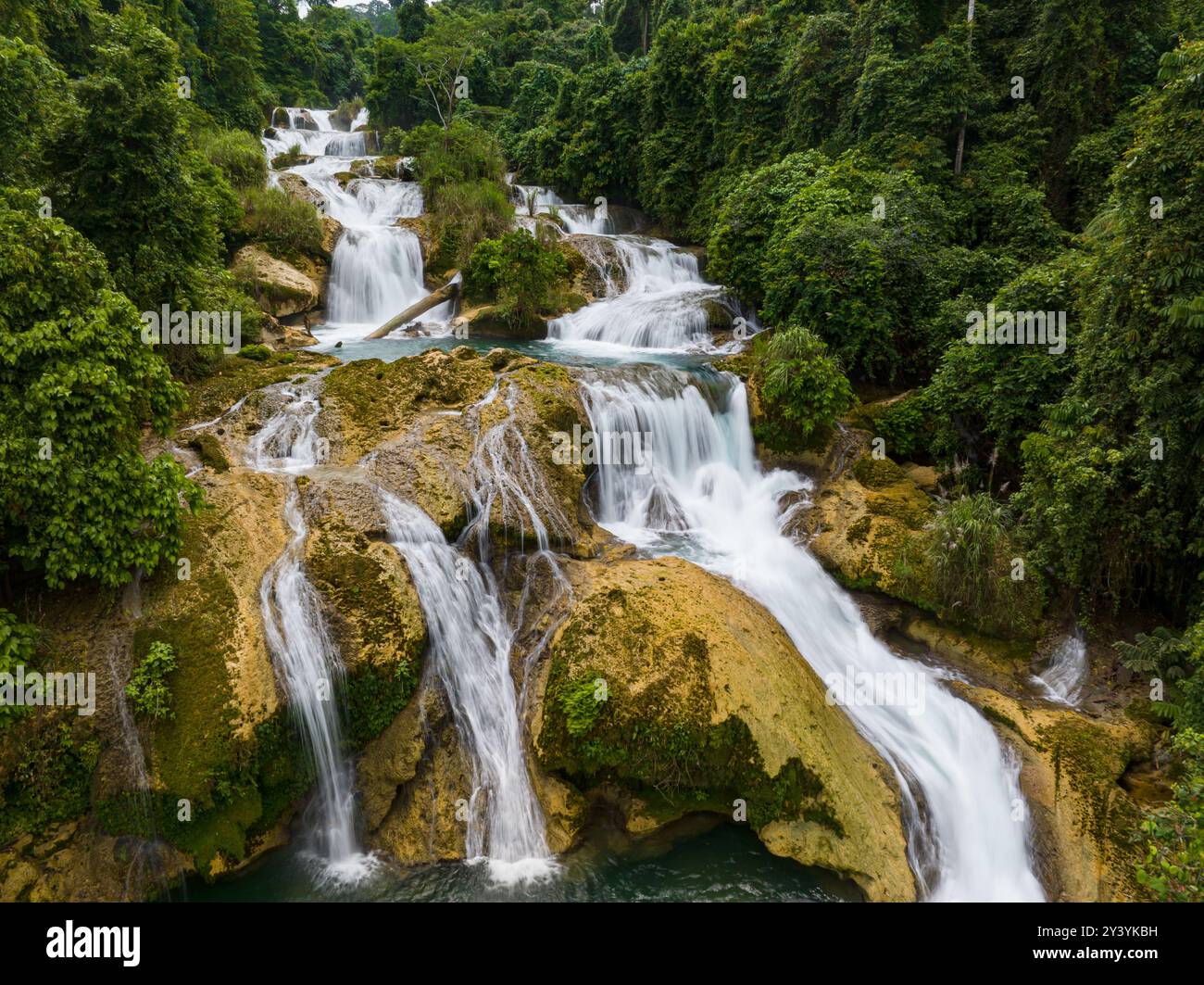 Tropical waterfalls with rapid stream over the rocks. Aliwagwag Falls ...