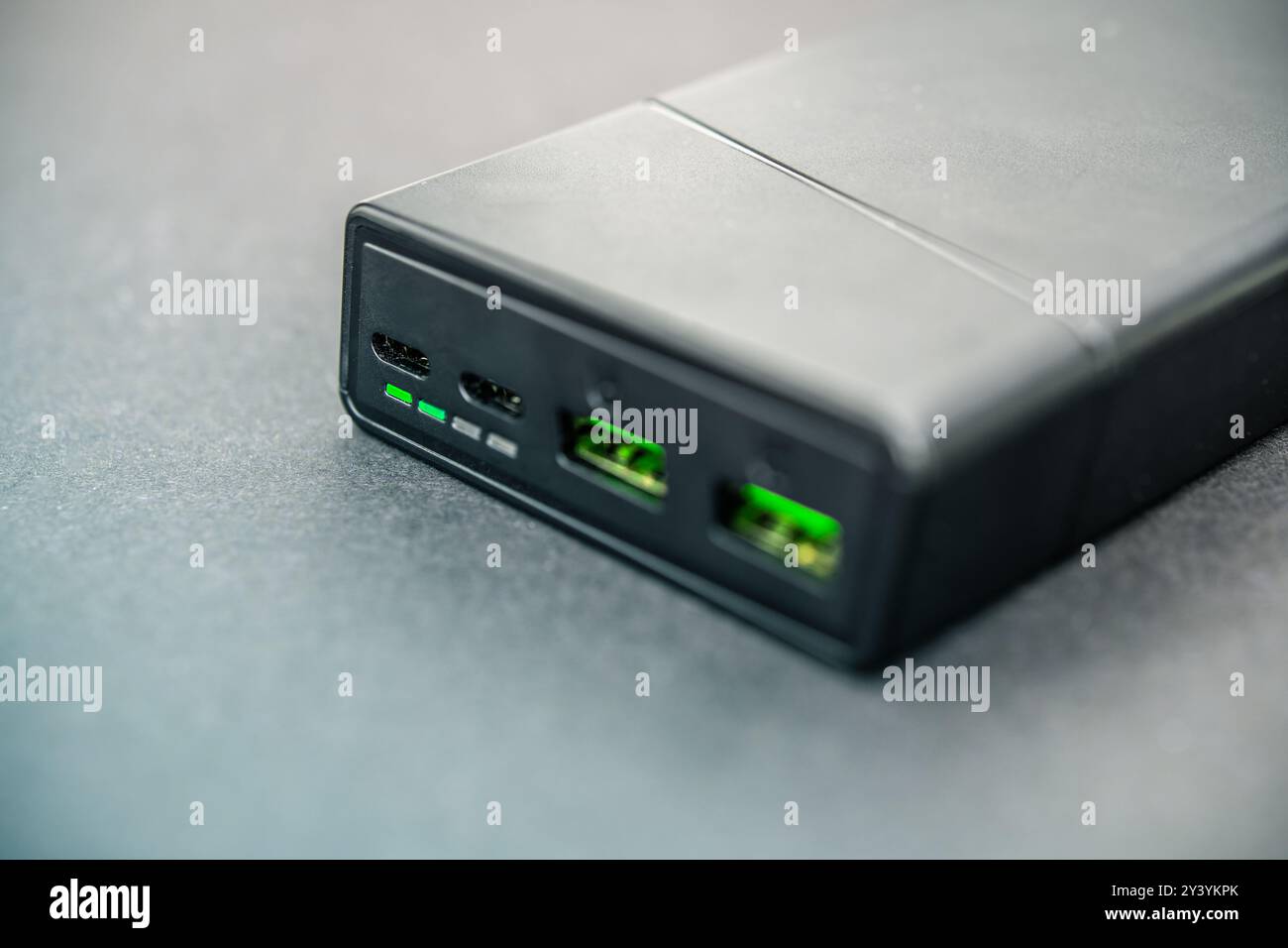 A detailed view of a portable power bank displaying USB-C and USB ports ...