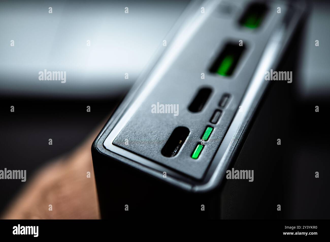 A sleek power bank featuring USB-C ports and illuminated charge ...