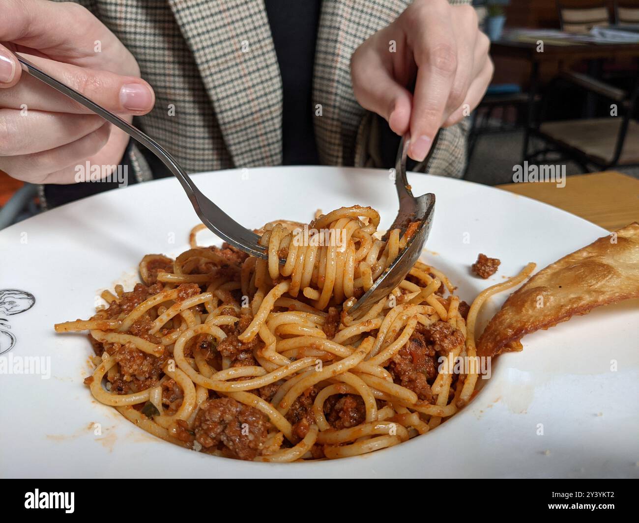 A man eating Italian pasta bolognese from a restaurant Stock Photo - Alamy