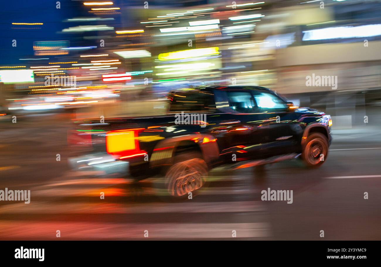 Black pick-up car moves fast through the city Stock Photo - Alamy
