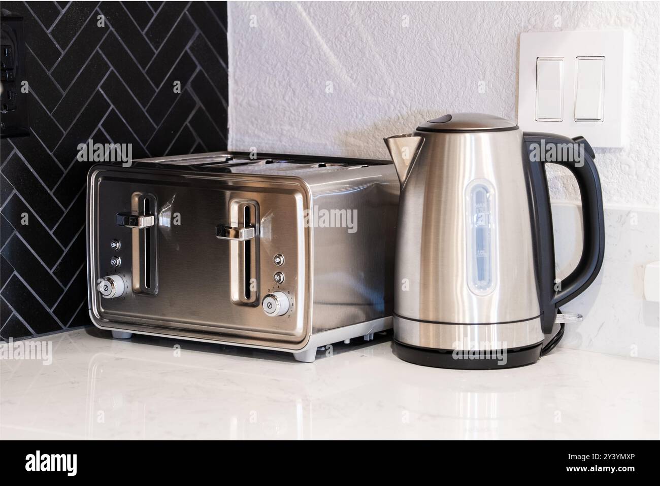 A modern stainless steel toaster and electric kettle on a kitchen ...