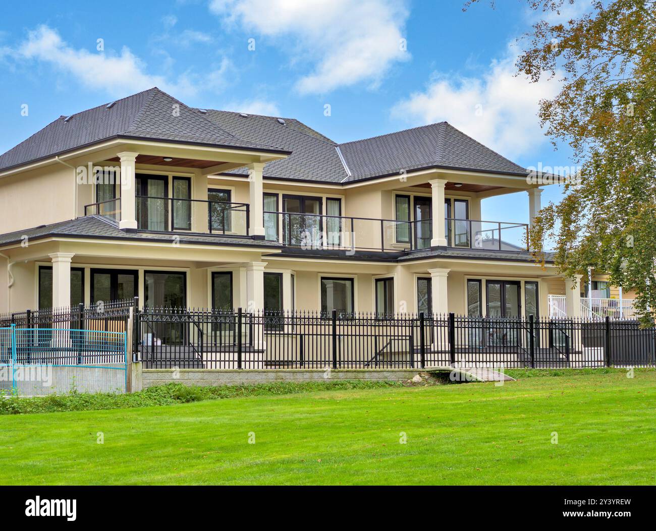 A perfect neighbourhood. New luxury residential house on cloudy sky ...