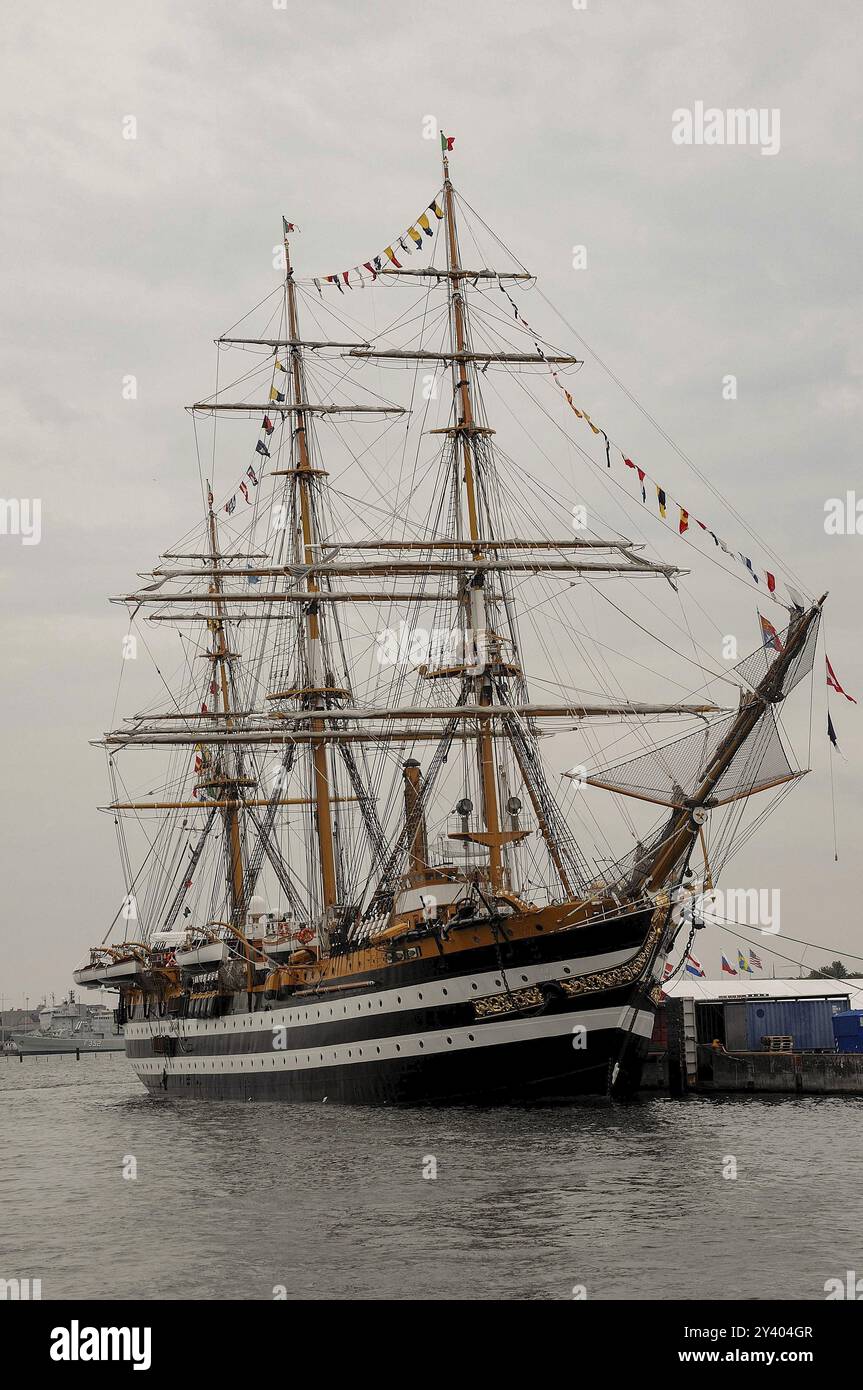 Historic sailing ship in the harbour with many masts and taut flags ...