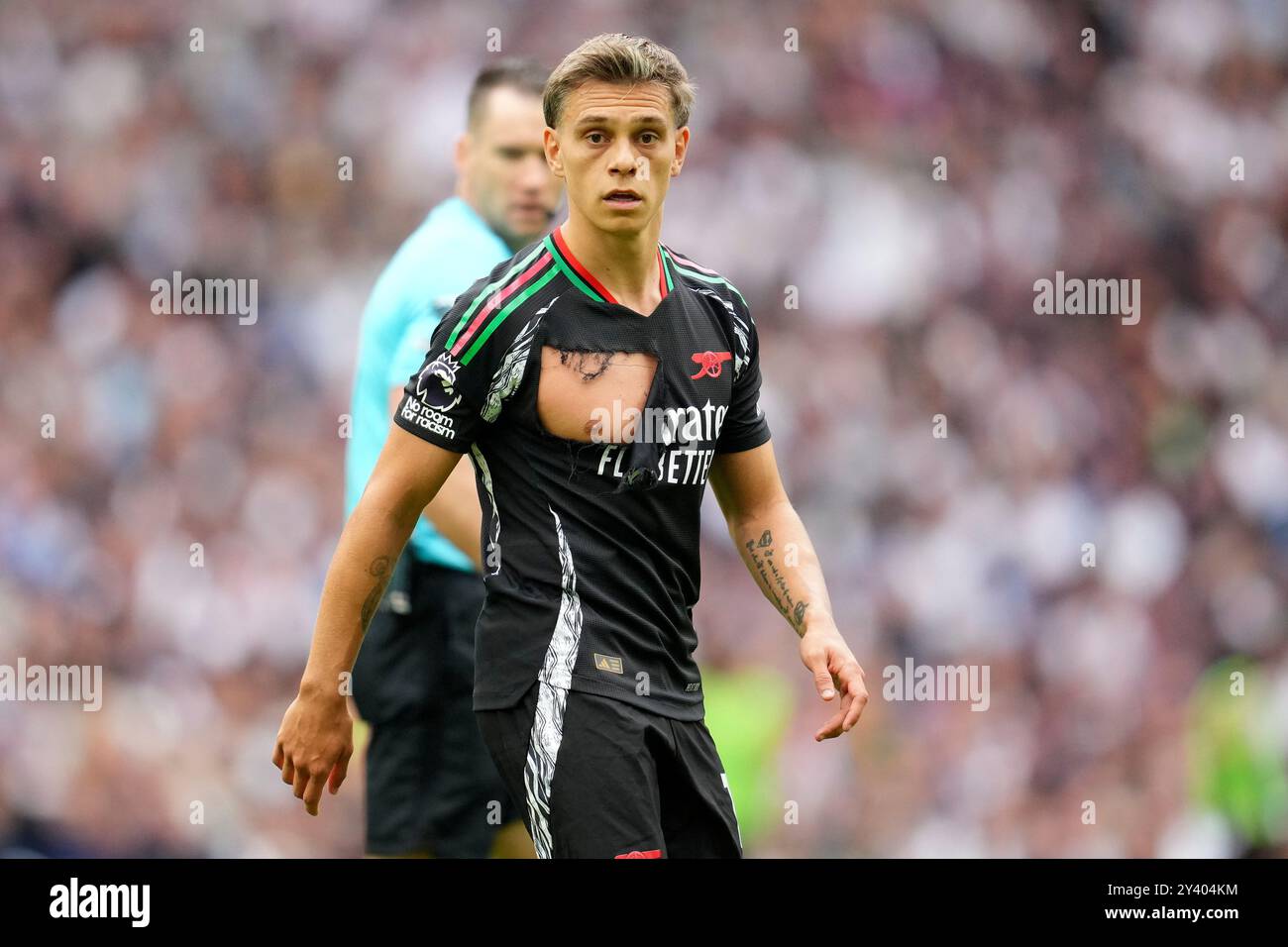 Arsenal's Leandro Trossard sports a ripped shirt during the English ...