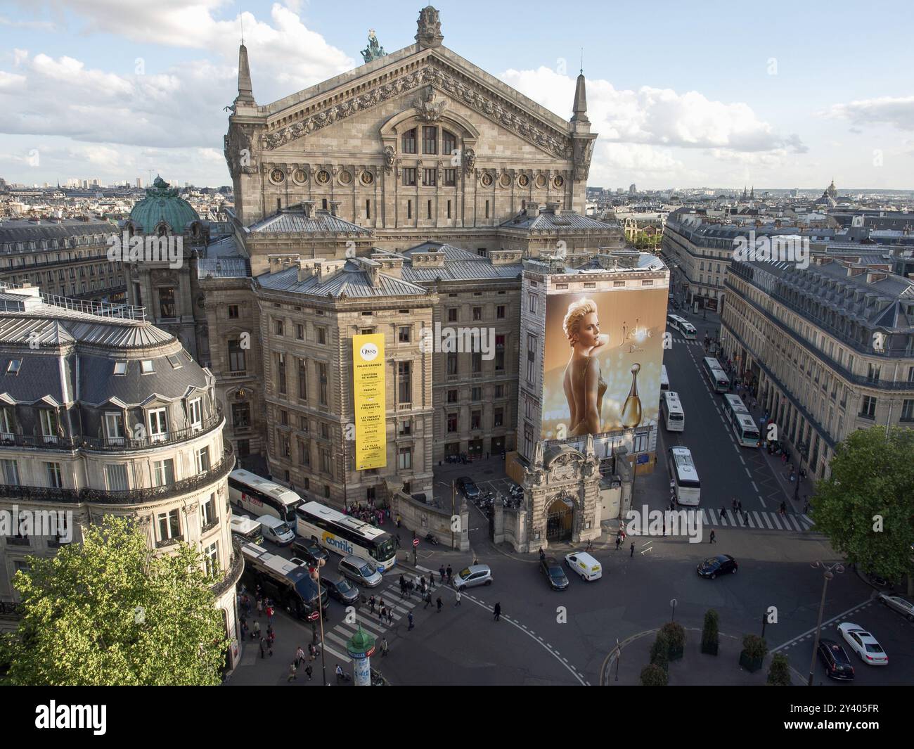 Historic building in Paris flanked by a busy street scene with buses ...
