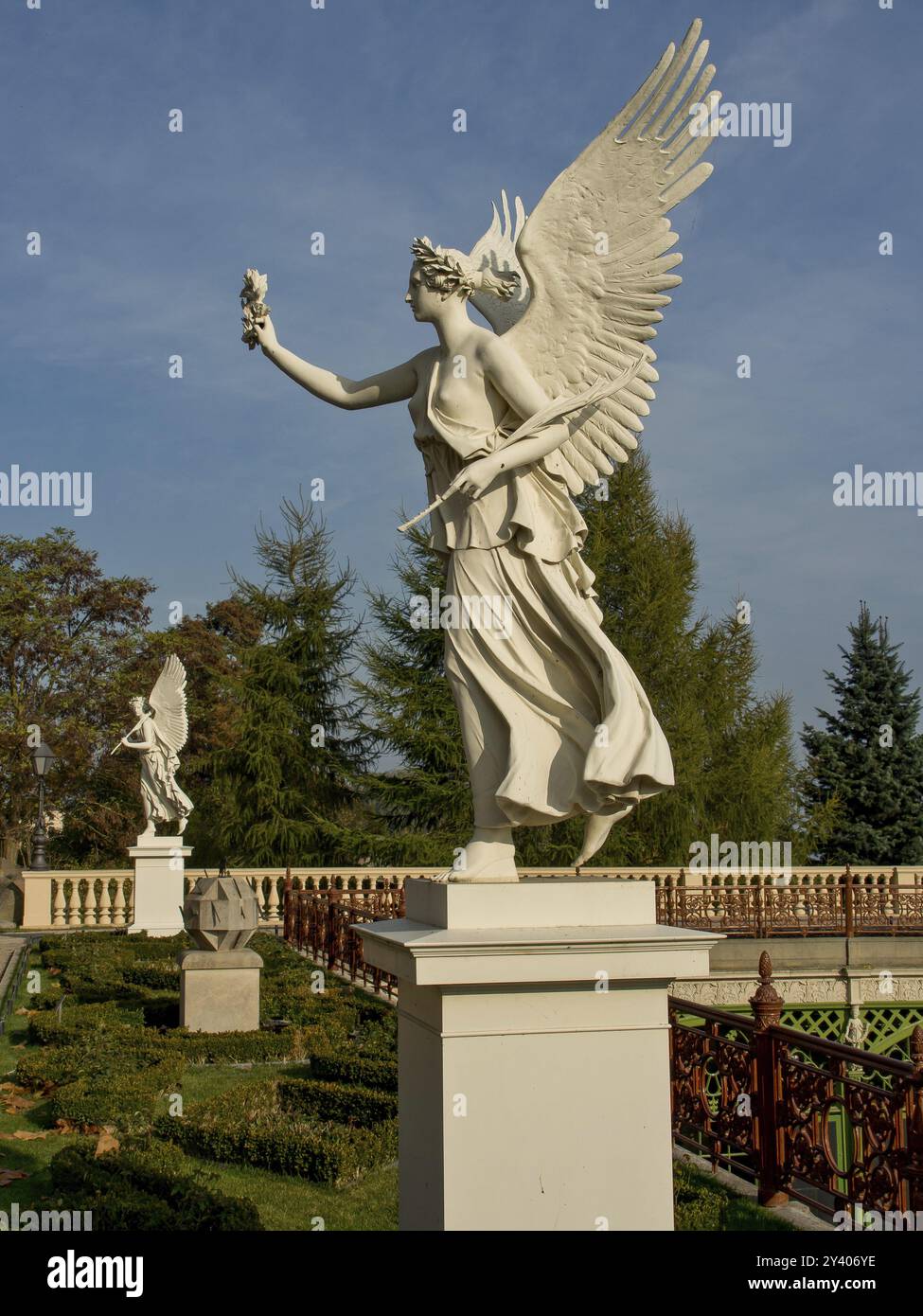 Angel statue in a garden with historical architecture, depicted with ...