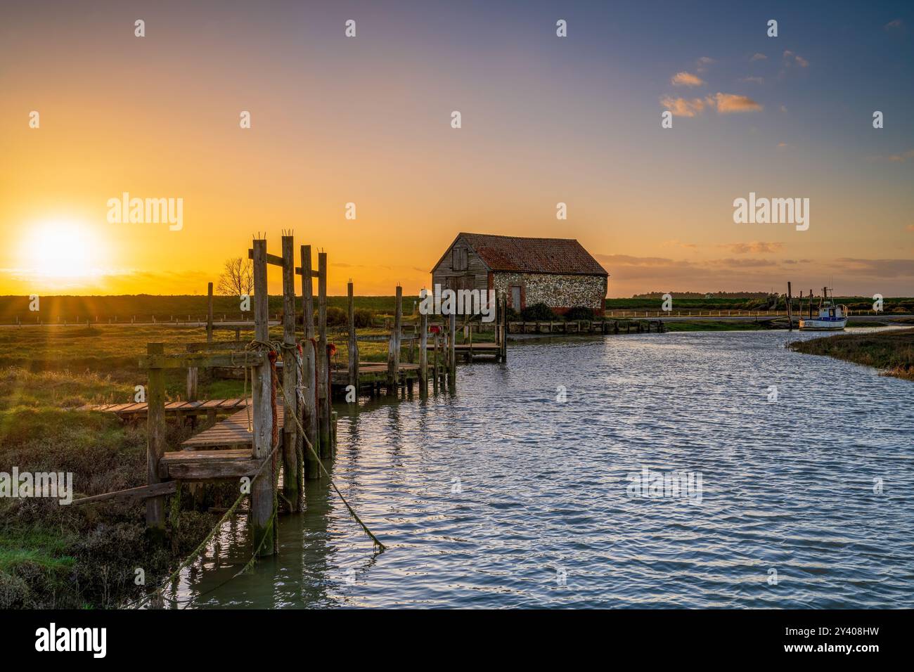The old Coal Barn and Quay at Thornham Old Harbour, during sunset ...