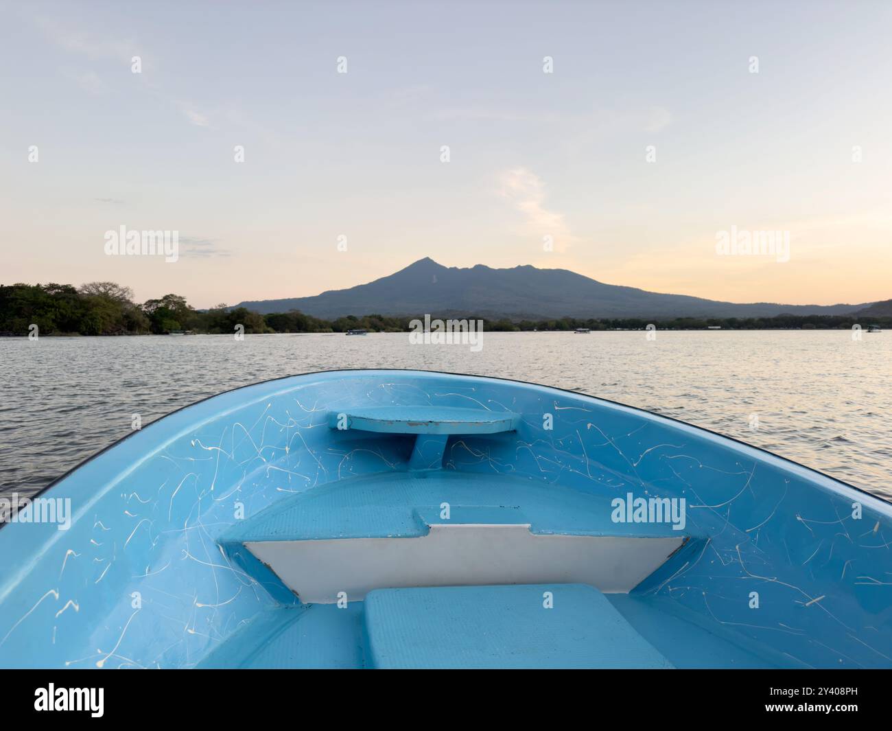 Tourism on boat theme. Blue small boat in volcano background Stock ...