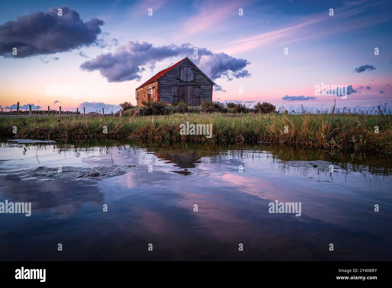The old Coal Barn and Quay at Thornham Old Harbour, during sunset ...