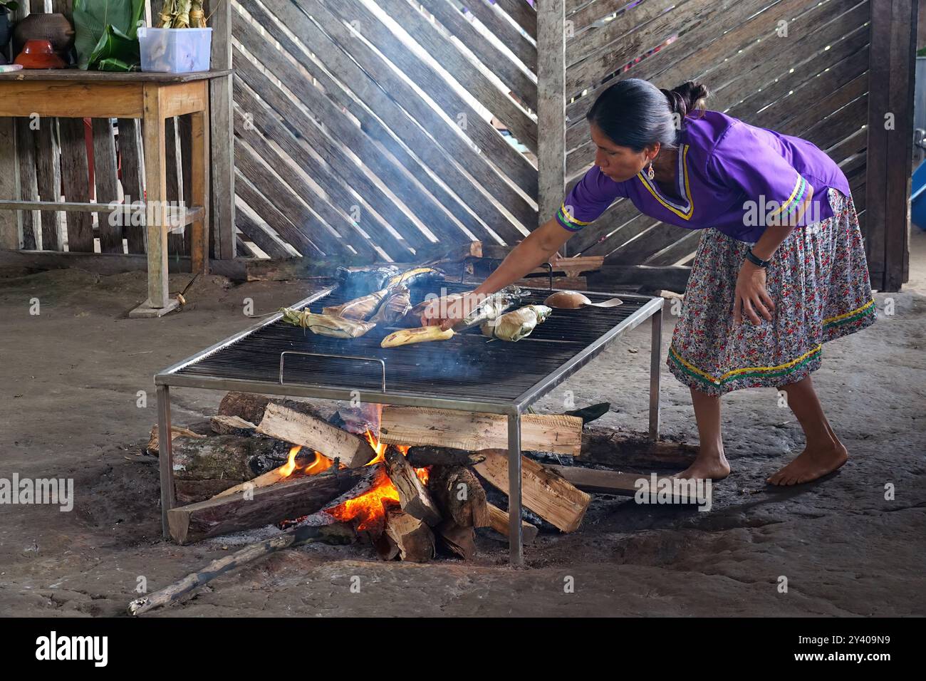 Kichwa woman cooking over an open fire, Sani community, Amazon ...
