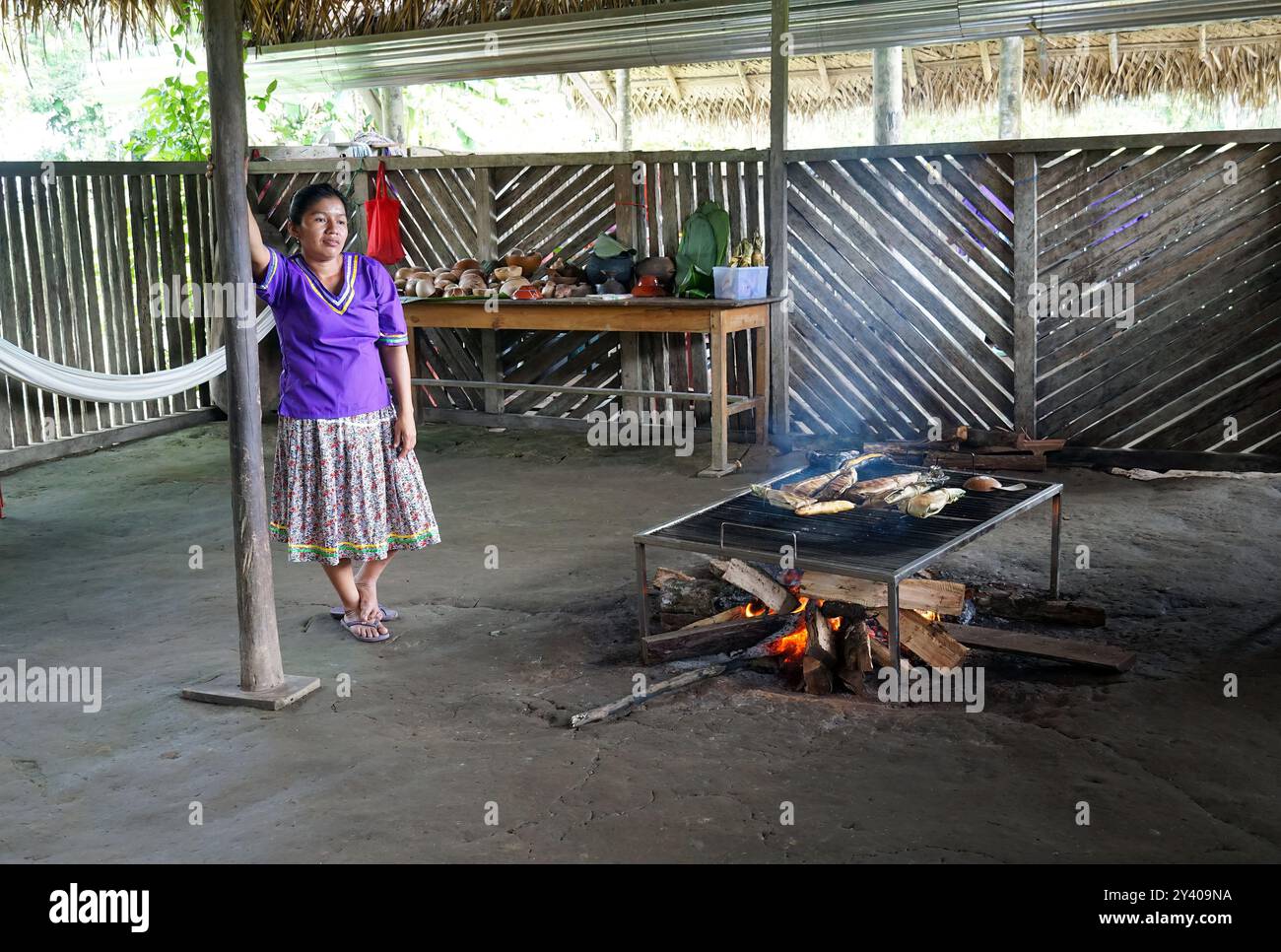 Kichwa woman cooking over an open fire, Sani community, Amazon ...