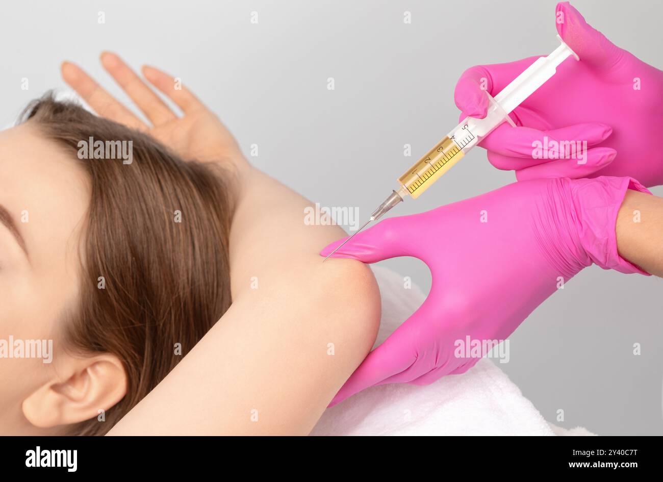 Doctor doing stem cell therapy on a patient's elbow after the injury. Treating knee pain with ...