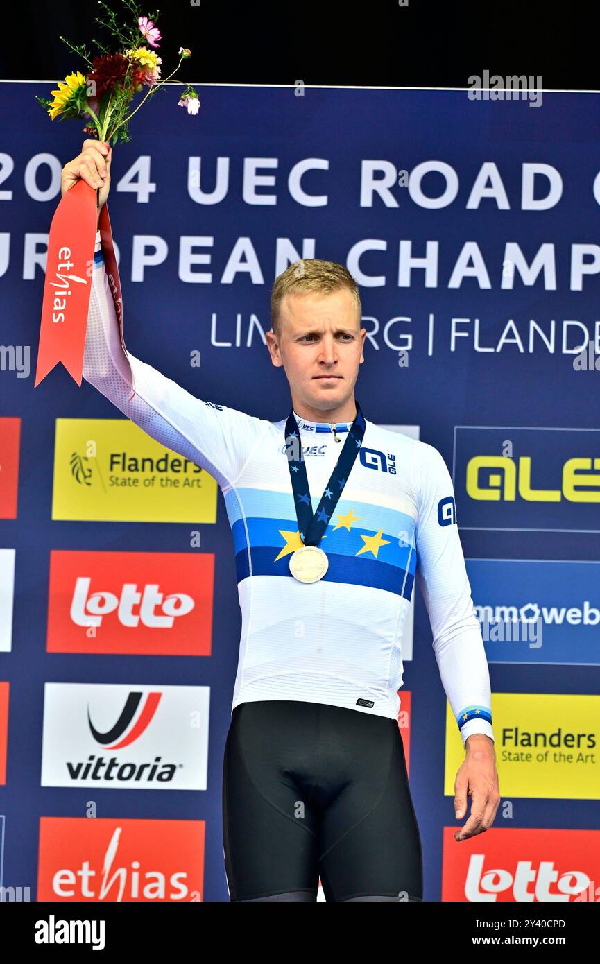 Winner European champion Belgian Tim Merlier celebrates on the podium ...