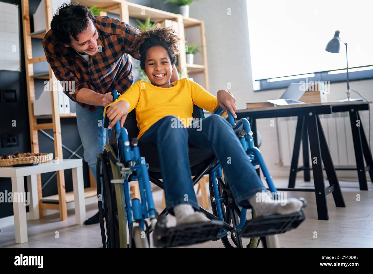 Happy multiethnic family with child with disability in wheelchair Stock ...