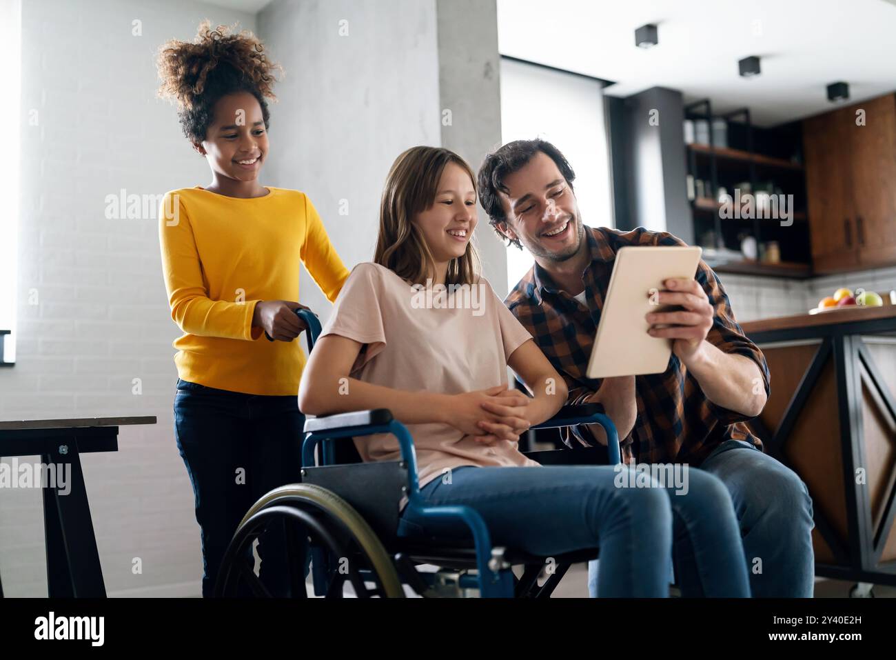 Happy multiethnic family with child with disability in wheelchair Stock ...