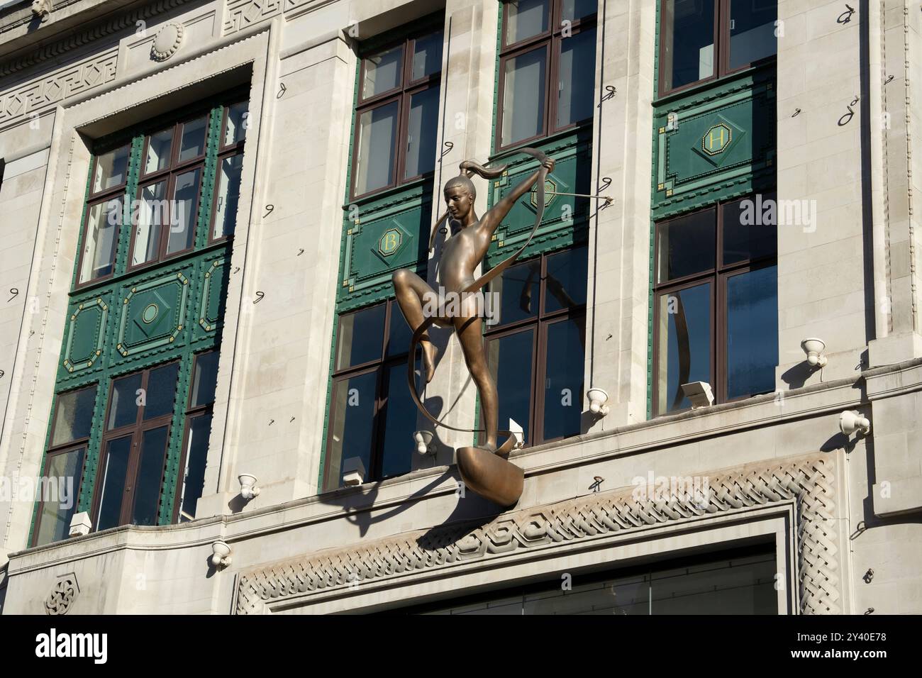 Bronze sculpture of a gymnast, on the exterior of a building on Oxford ...