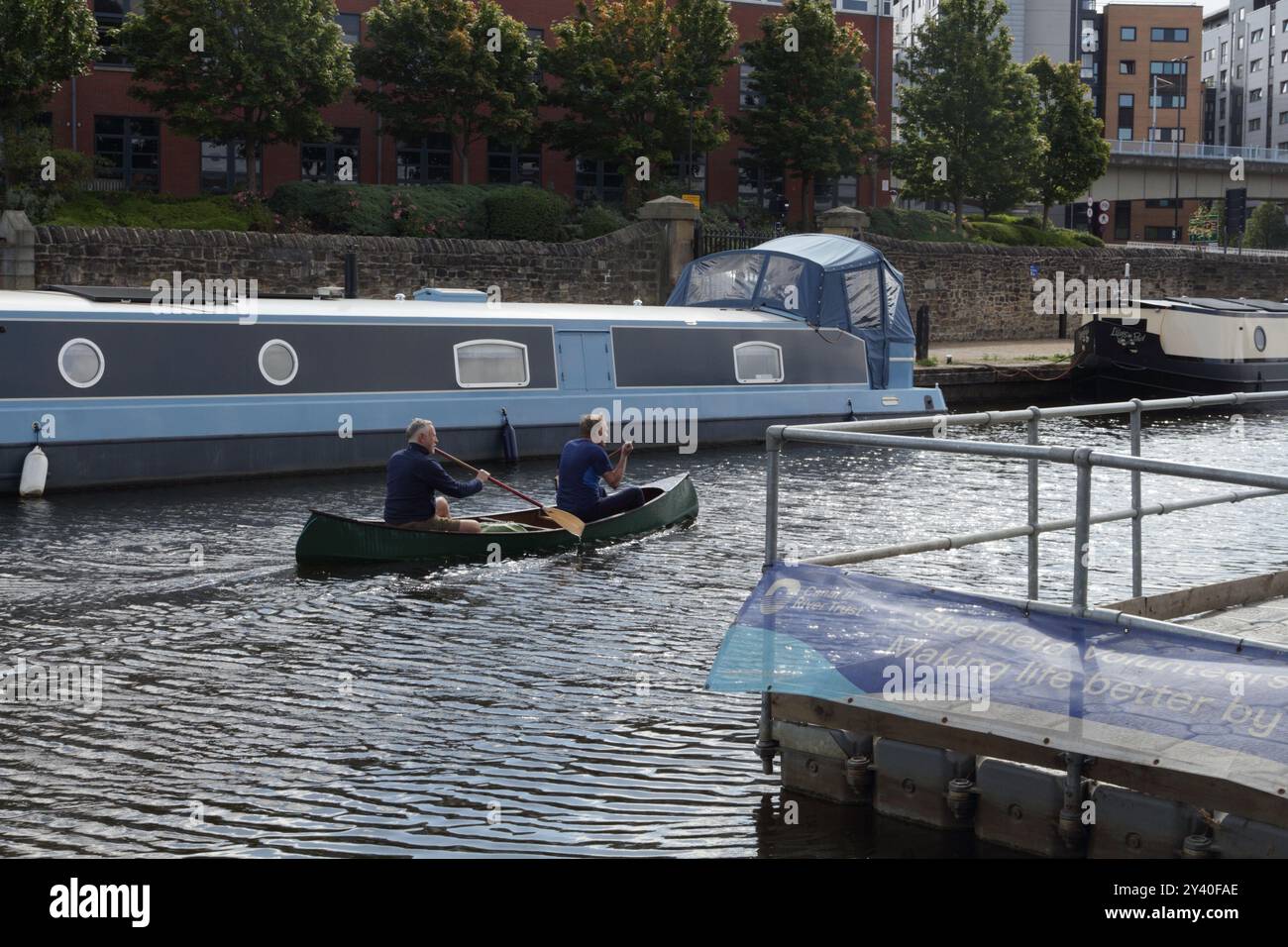 Two people rowing a canoe, Sheffield canal basin England UK, waterway ...