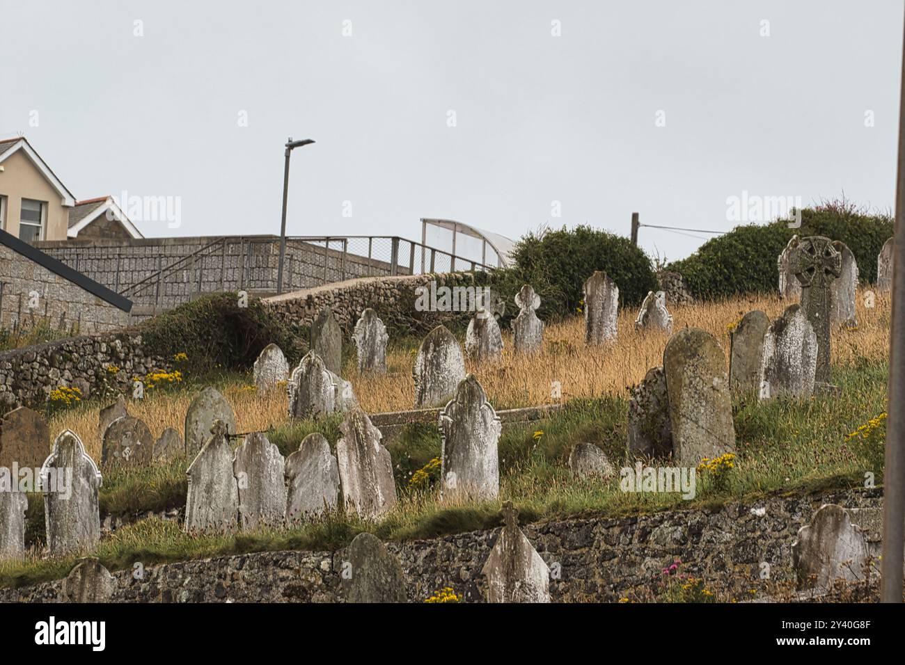 A historic graveyard with weathered tombstones on a hillside ...