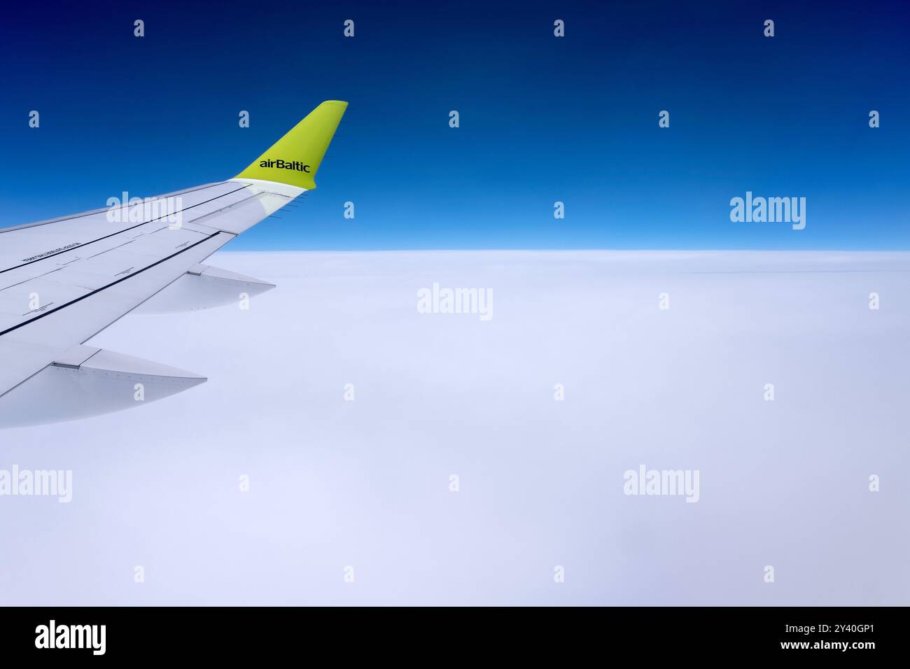 Airbus A220-300 flying above sea of clouds into clear blue sky Stock ...