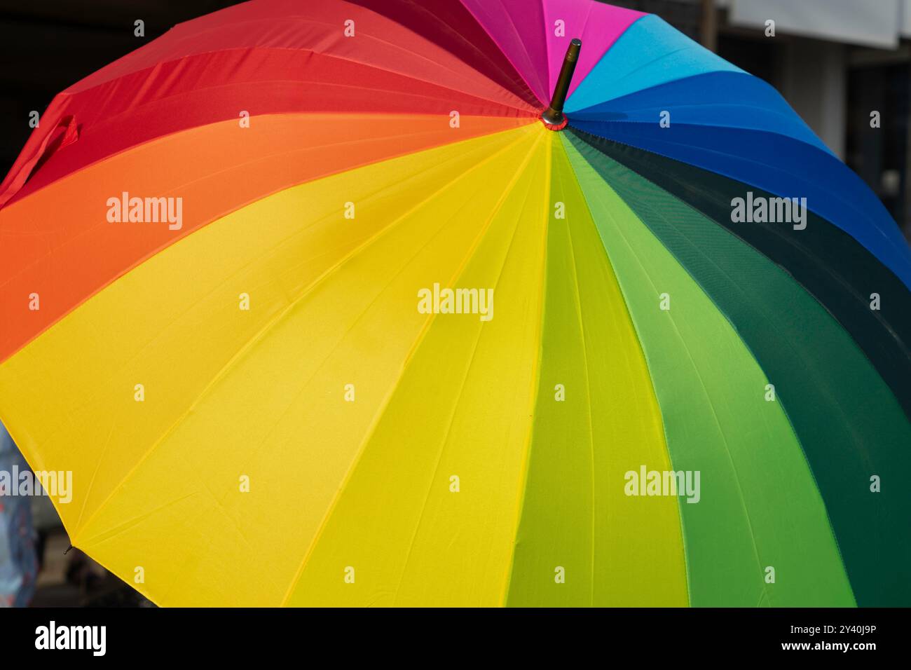 Rainbow umbrella in LGBT Pride festival parade Stock Photo - Alamy