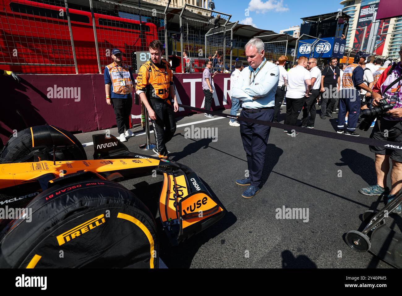 FIA steward looking at the front wing of the McLaren F1 Team MCL38 ...