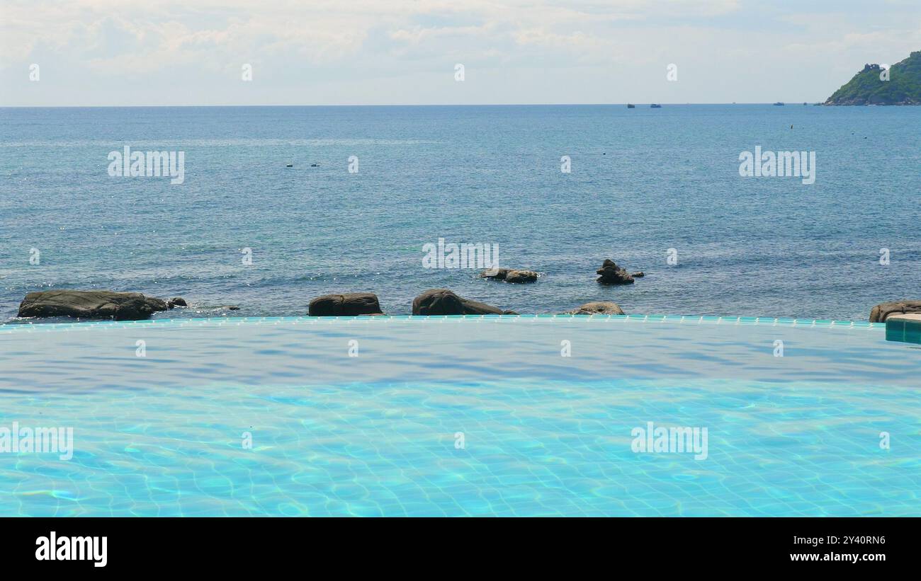 Infinity pool overlooking tranquil ocean, showcasing serene coastal ...