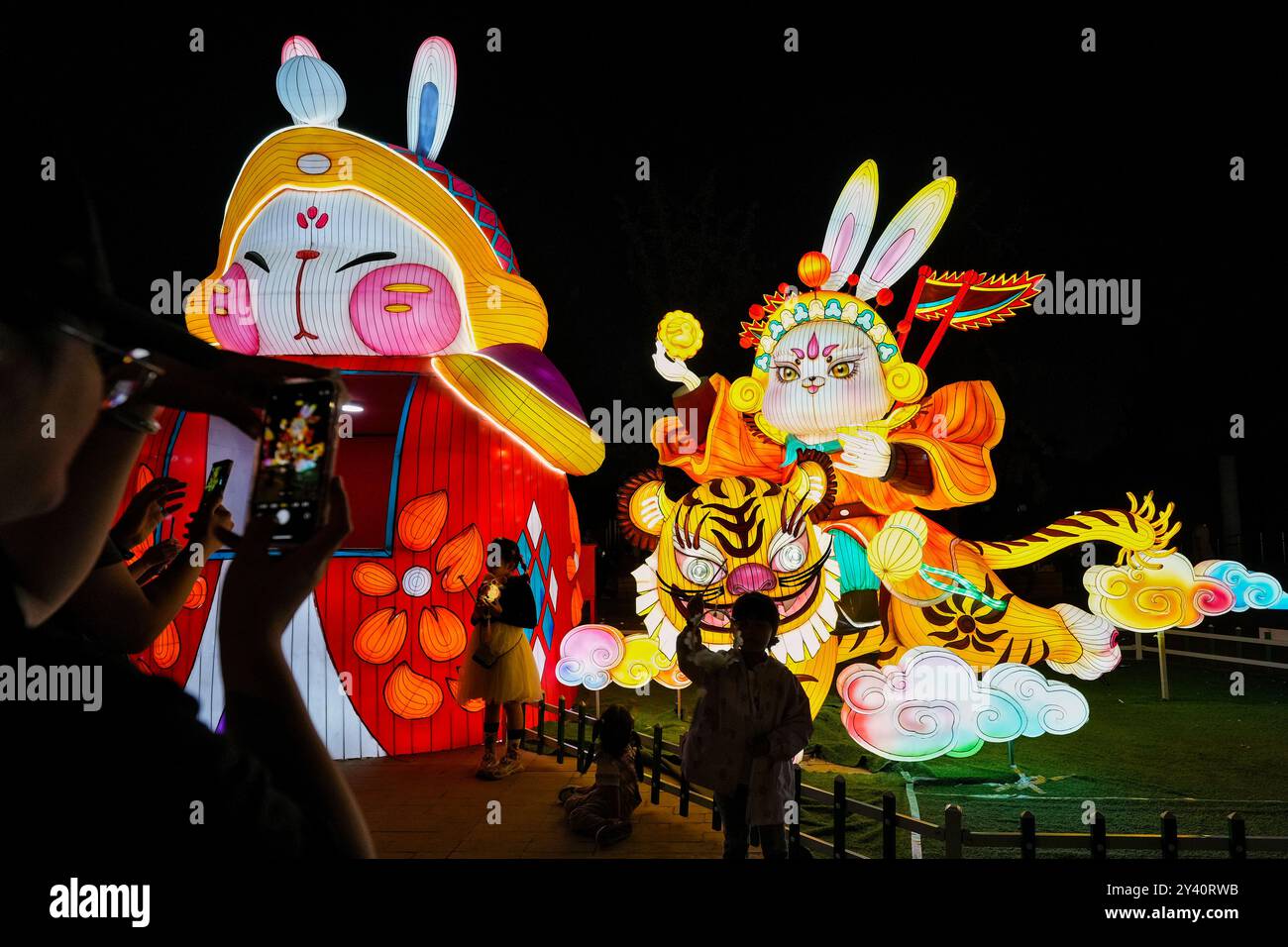 Visitors take souvenir pictures of the grand lantern show on display at ...
