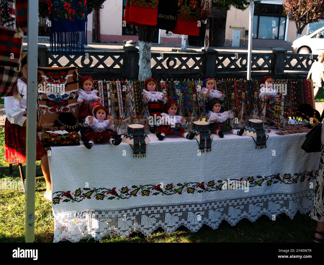 Dolls dressed in traditional Romanian folk costumes are set over ...