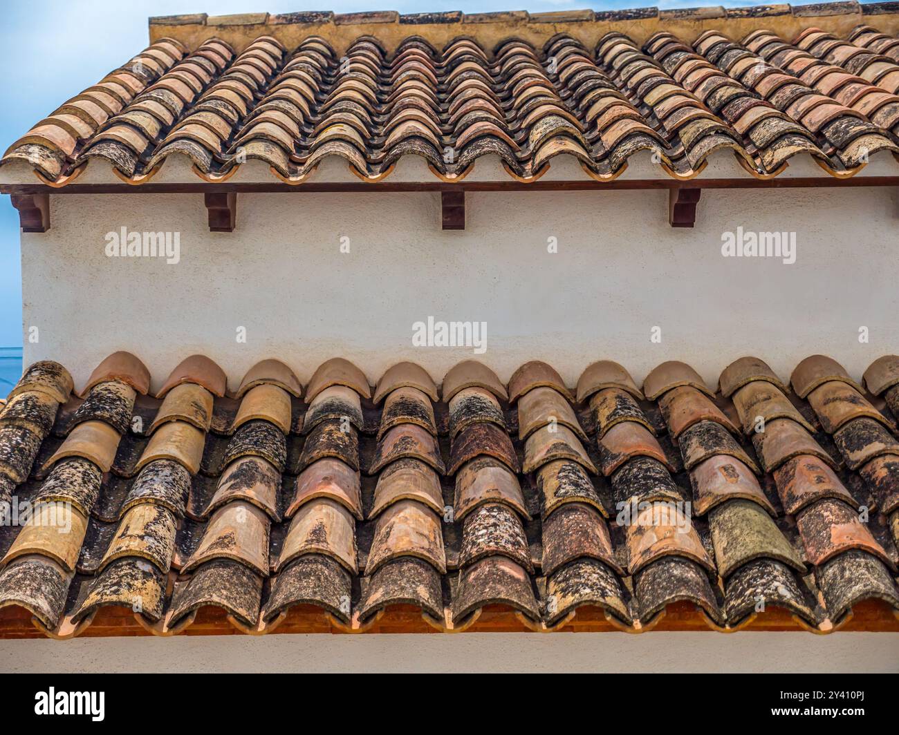 Traditional terracotta roof with curved, clay tiles arranged in a ...