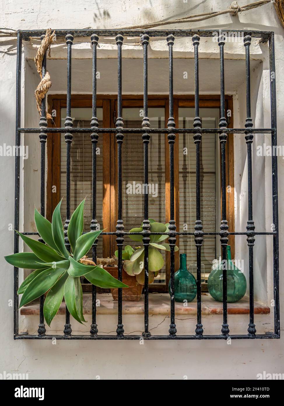 Typical spanish house window with window grill decorated with house ...