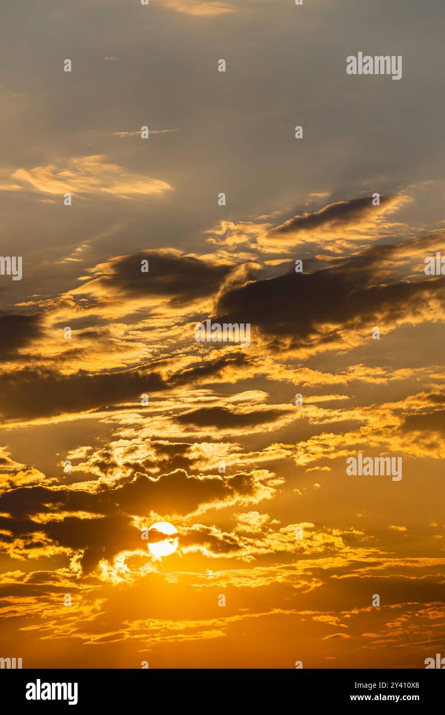 the evening sky illuminated by the sun hidden behind a cloud. evening ...