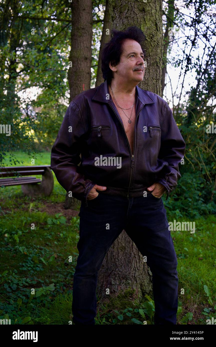 Good looking man in a dark leather jacket Stock Photo - Alamy