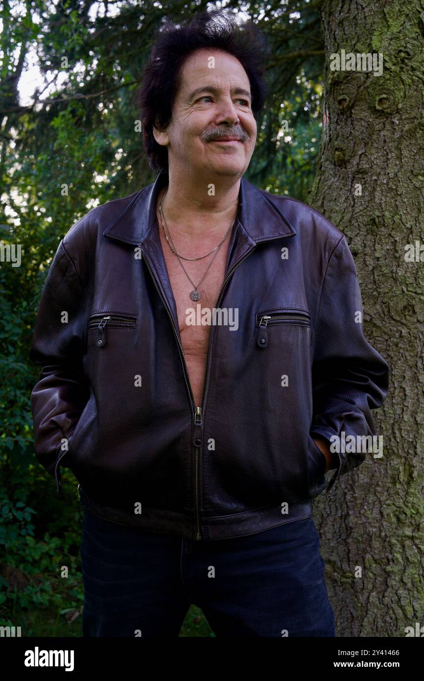 Good looking man in a dark leather jacket Stock Photo - Alamy