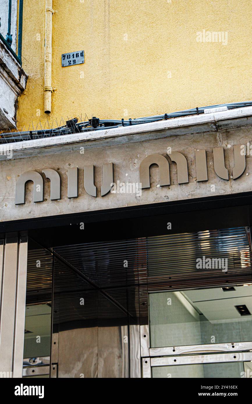 The elegant Miu Miu storefront features distinctive modern ...