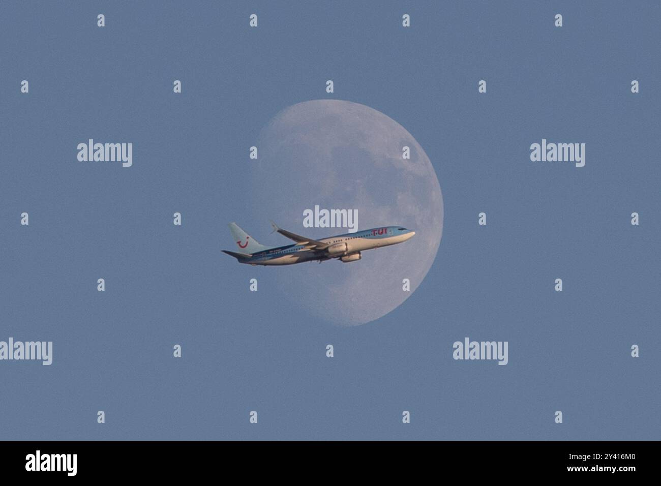 A Tourism Union International (TUI) commercial jet flies in front of ...