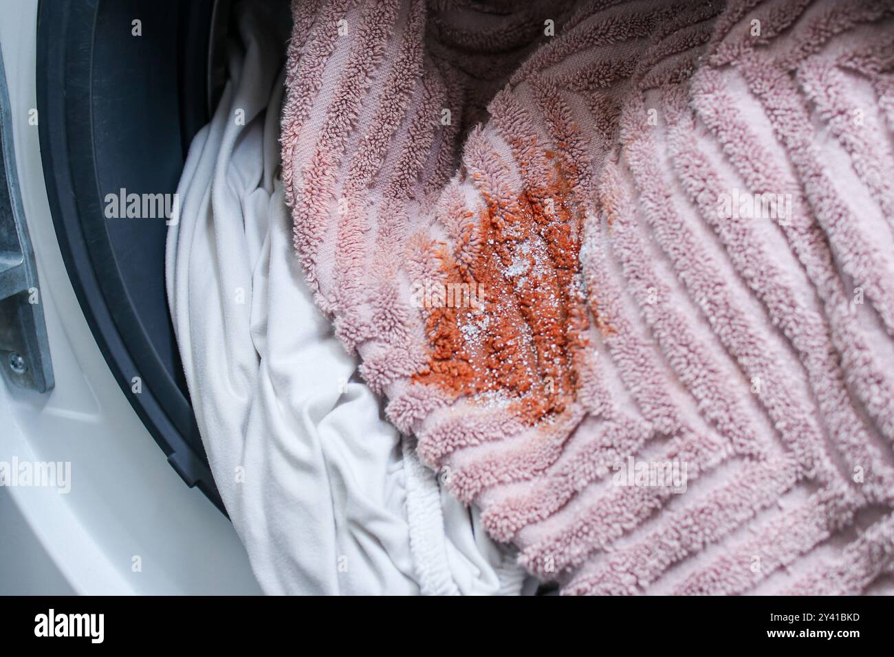 Dirty cloth with a red spot in a washing machine Stock Photo - Alamy