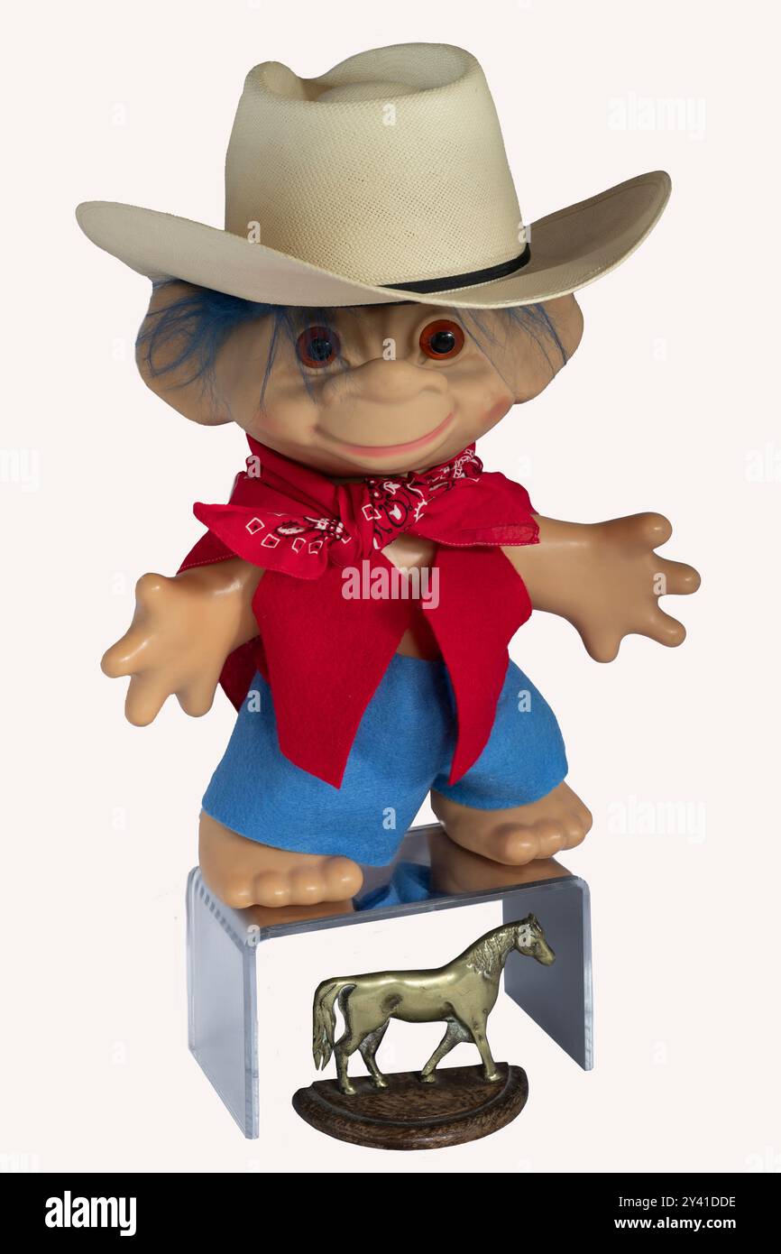 Little child troll with cowboy hat & red bandana stands with his toy ...