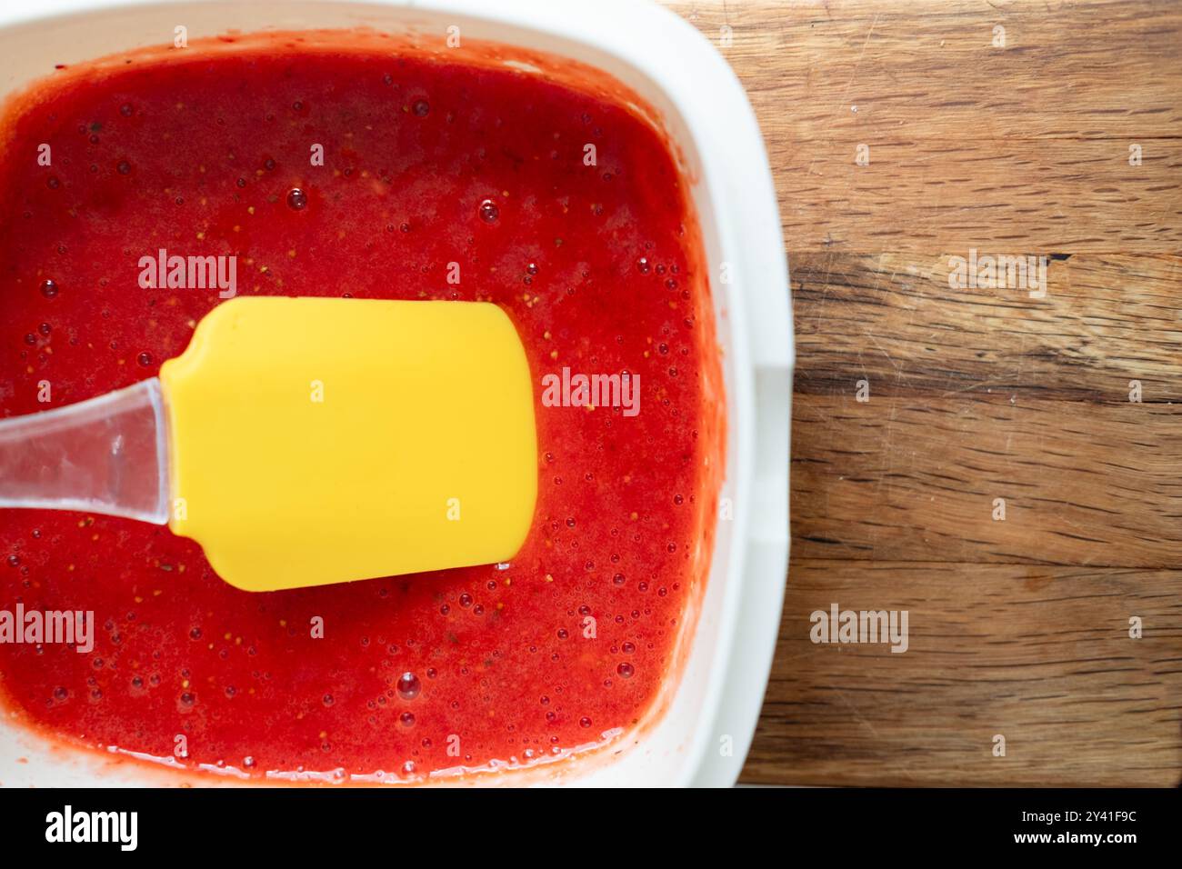 red and liquid jelly in a strawberry container, after a blender Stock ...
