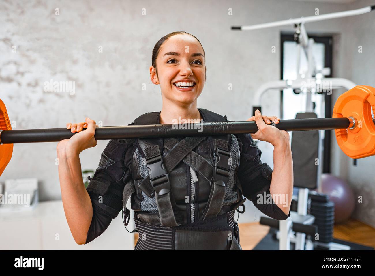 Energetic woman lifts weights in training session at gym Stock Photo ...