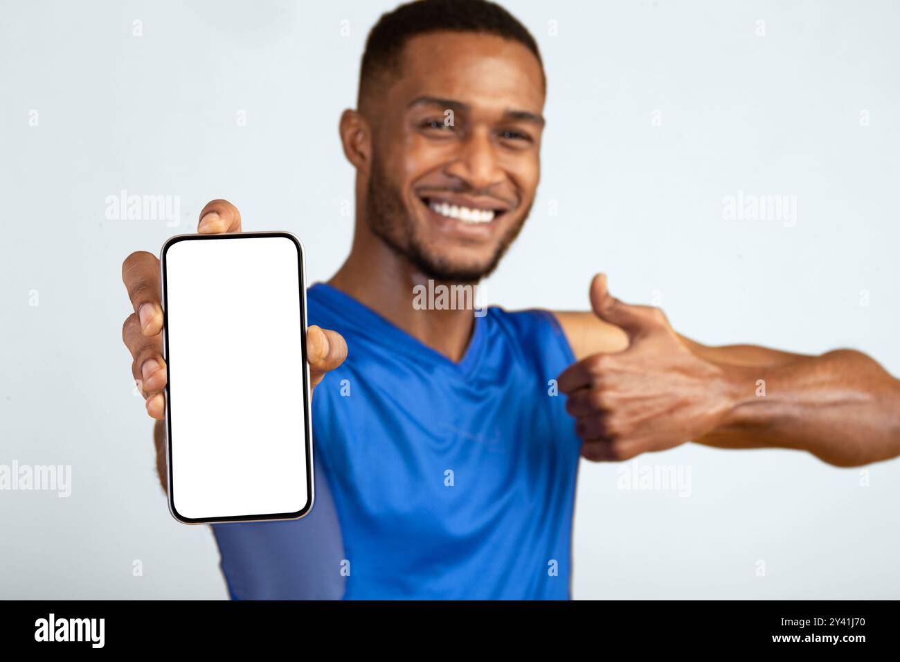 Black millennial guy showing blank phone screen Stock Photo - Alamy