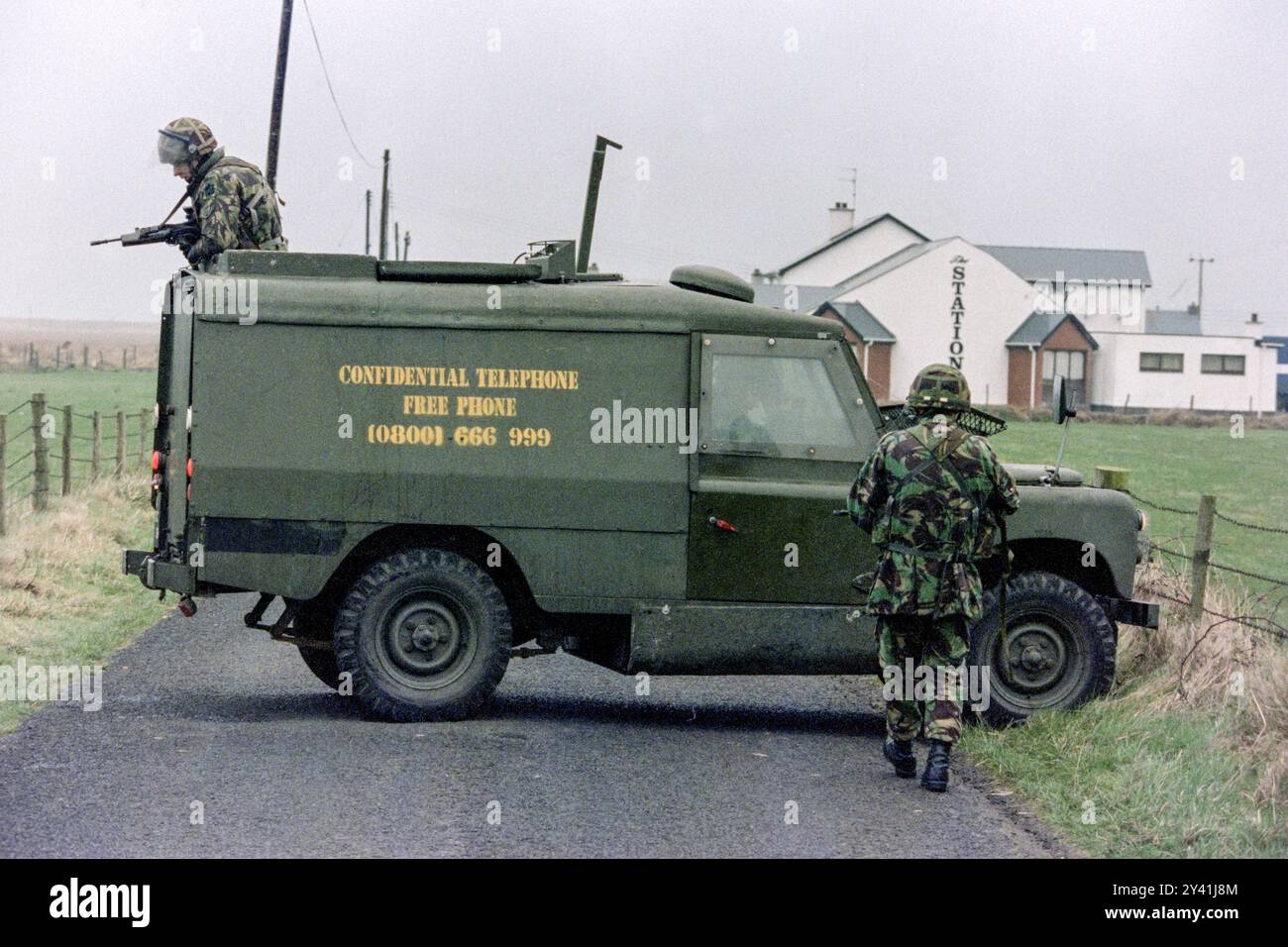 British soldiers use an armored Land Rover to secure a road checking ...