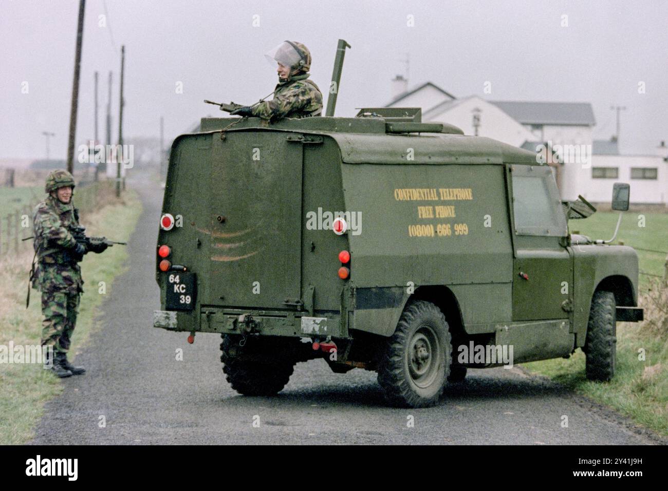 British soldiers use an armored Land Rover to secure a road checking ...