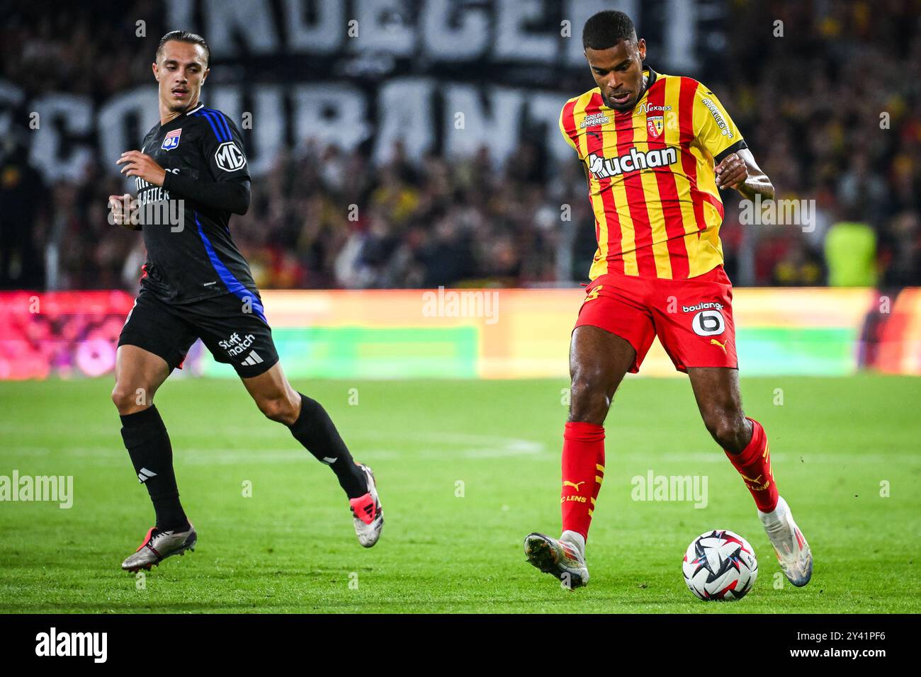 Maxence CAQUERET of Lyon and Andy DIOUF of Lens during the French ...