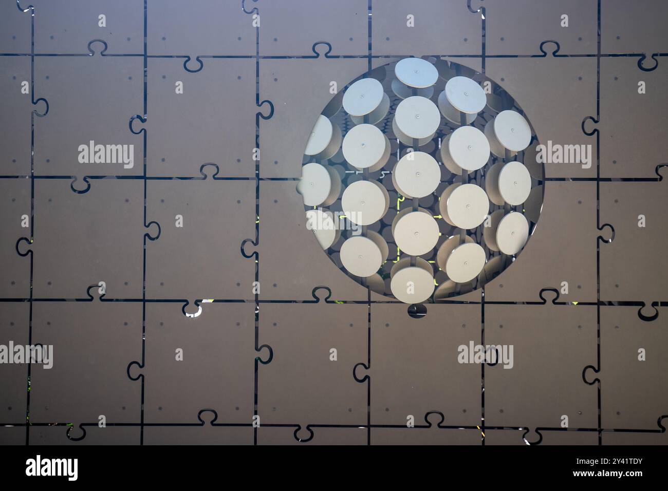 Puzzle pieces on a wall: gray, fitting perfectly, creating a unique and ...