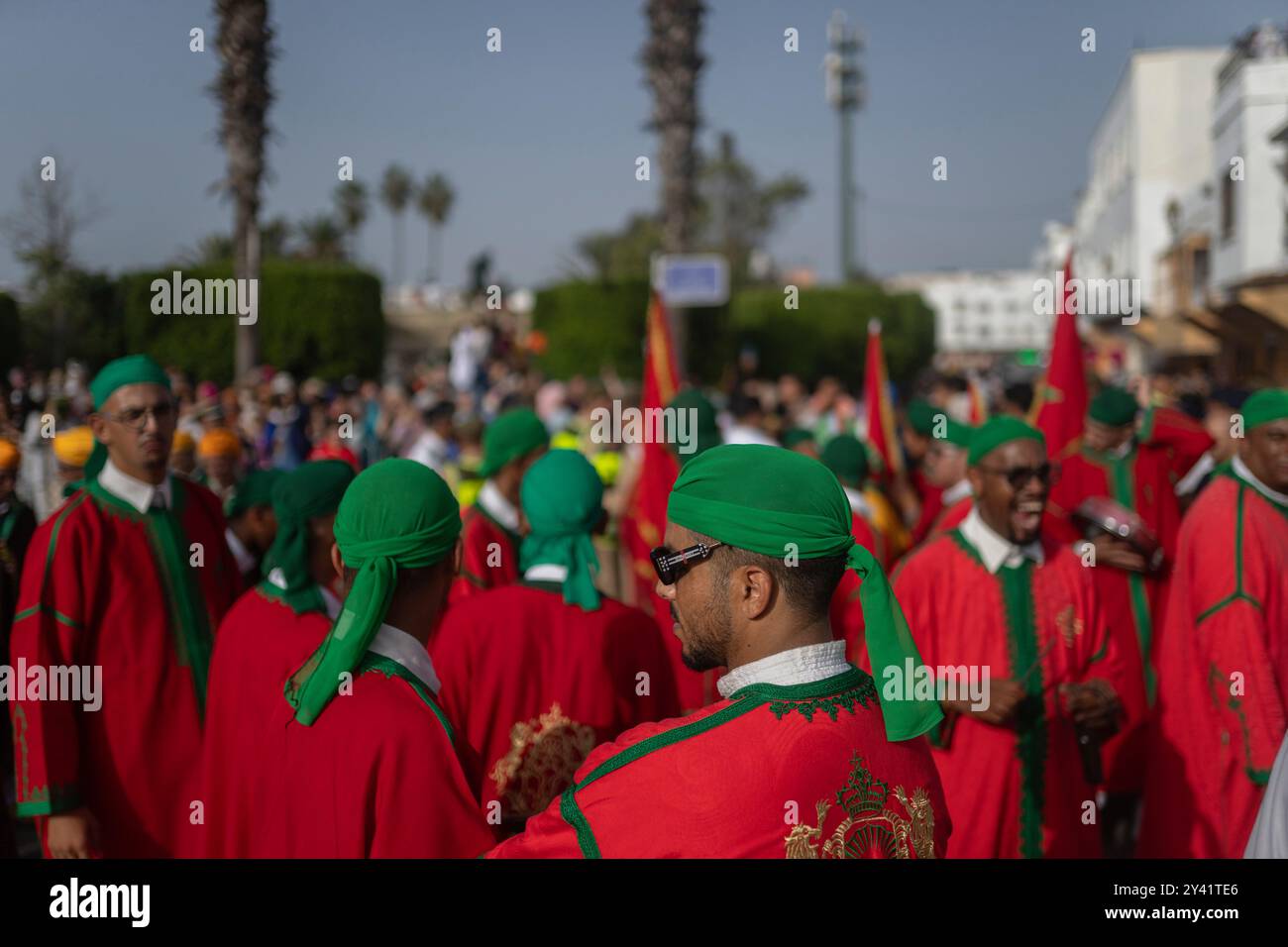 People wearing traditional outfits take part in a parade celebrating ...